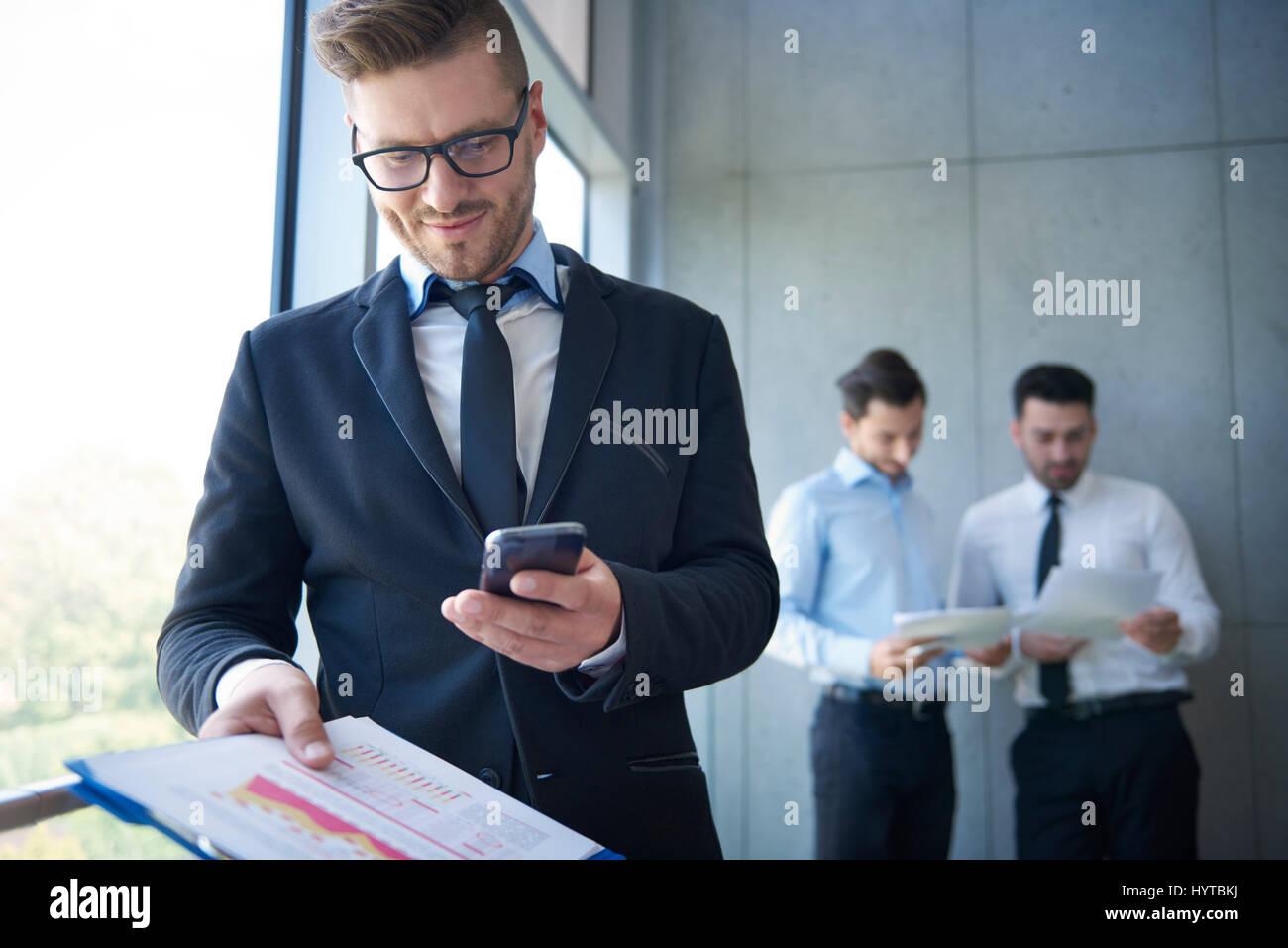 Man in suit using a smartphone Stock Photo - Alamy