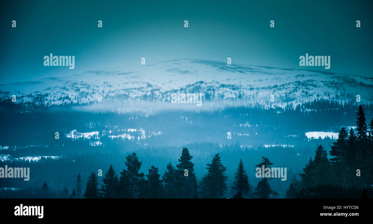 A beautiful, dramatic, colorful winter landscape with mountains in ...