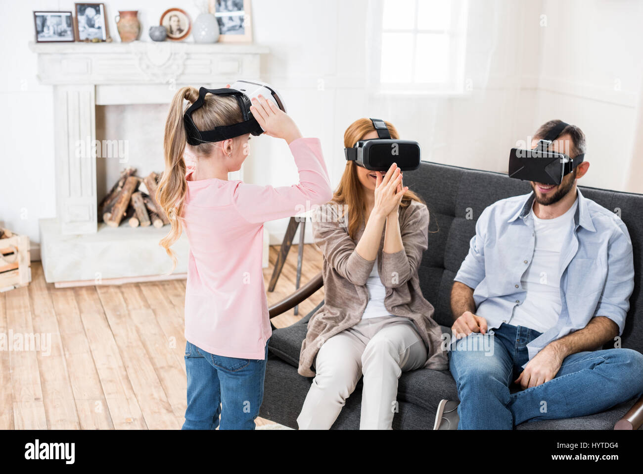 Happy family having fun together in virtual reality headsets Stock ...