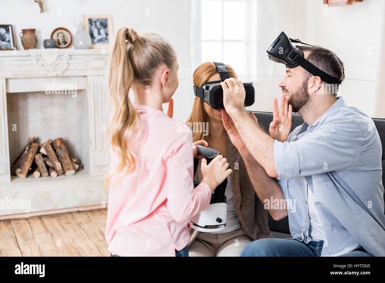 Happy family having fun together in virtual reality headsets Stock ...