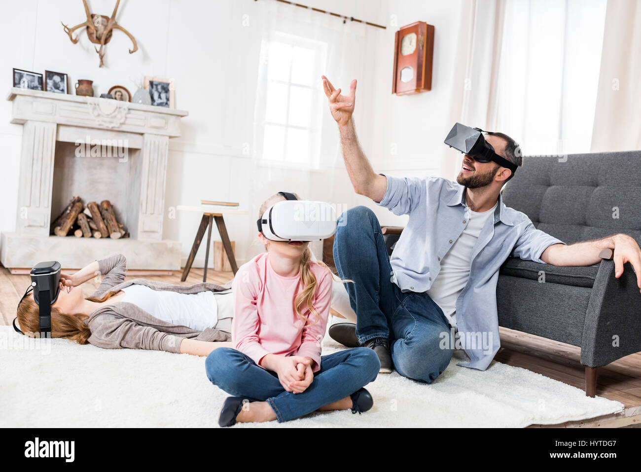 Family using virtual reality headsets while sitting and gesturing Stock ...