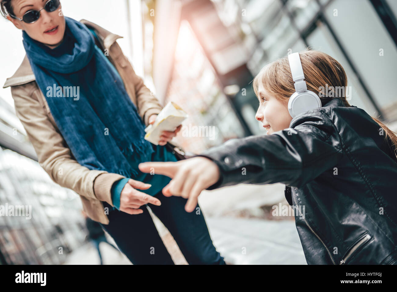 Daughter listening to music and talking with mother Stock Photo - Alamy