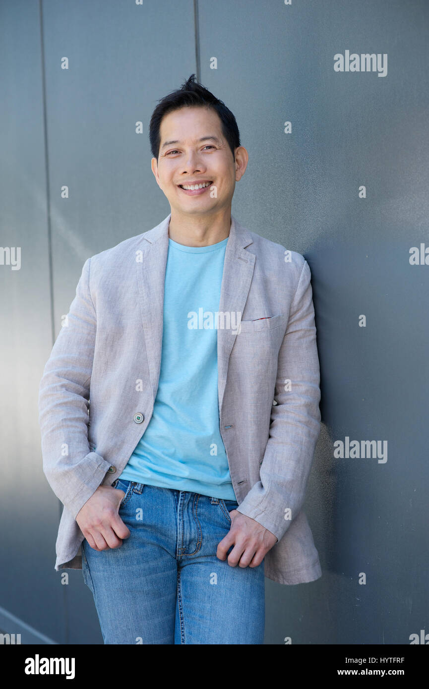 Portrait of a smiling asian man standing outdoors Stock Photo - Alamy