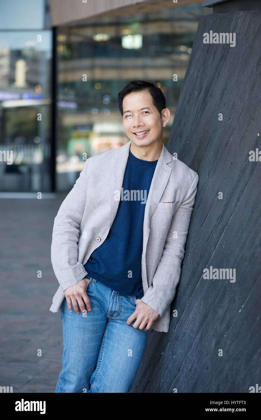 Portrait of a smiling asian man posing outdoors Stock Photo - Alamy