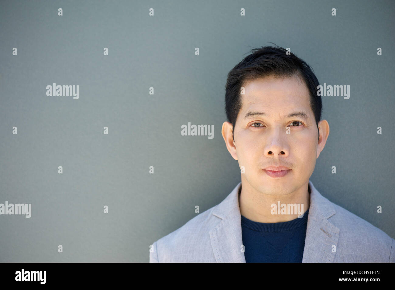 Close up horizontal portrait of an asian man with serious expression ...