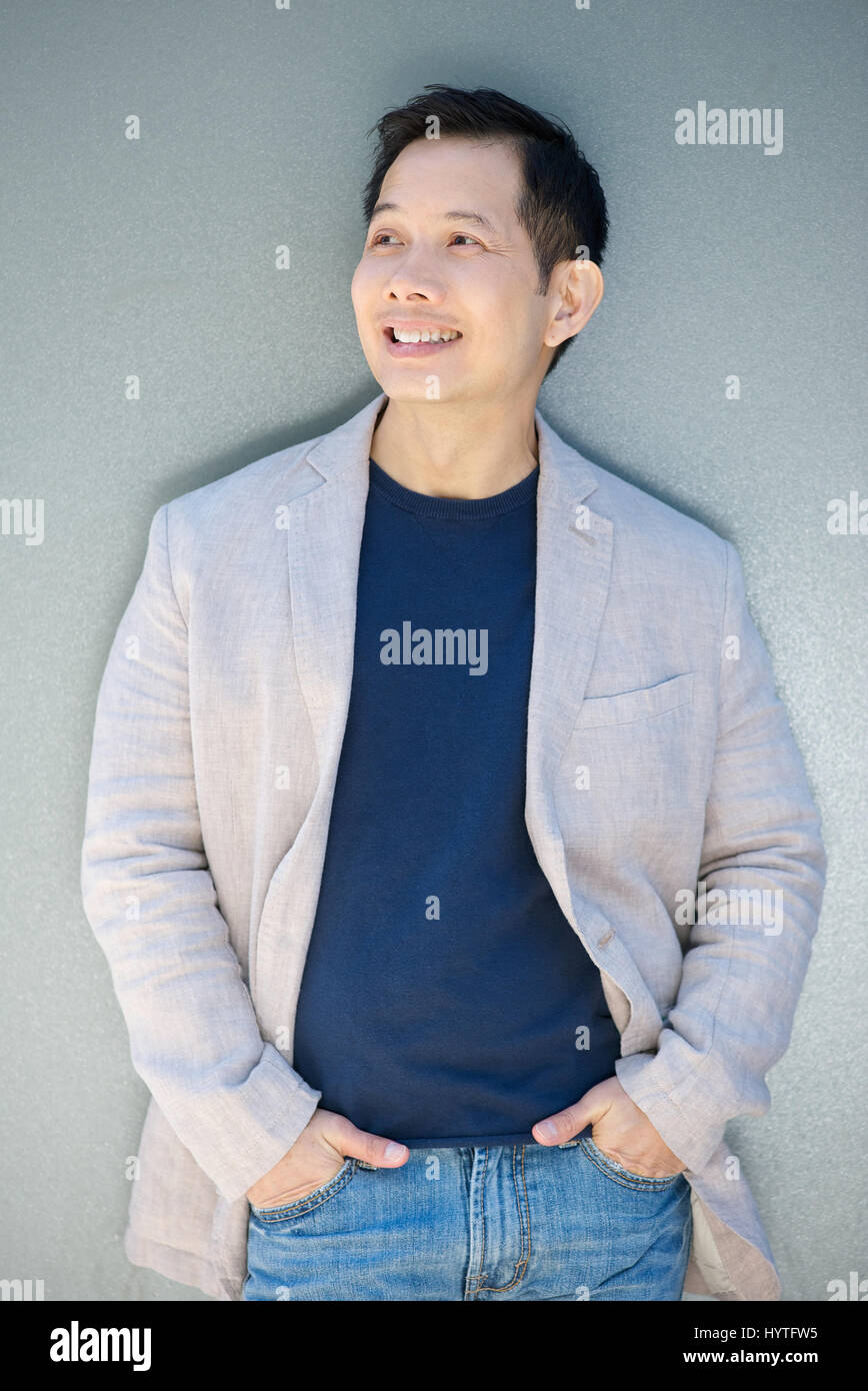 Portrait of a modern asian man smiling outdoors Stock Photo - Alamy