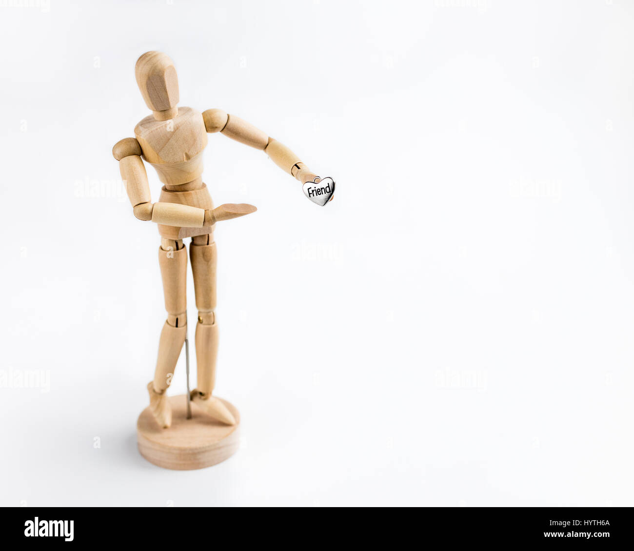 Mannequin pointing at a silver heart that says friend Stock Photo - Alamy