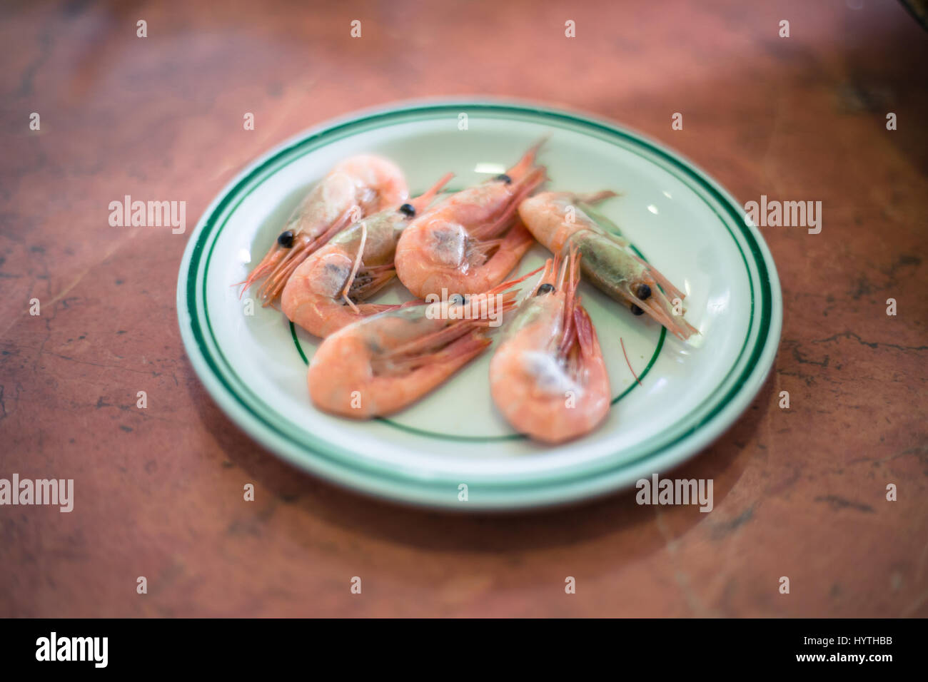 Crevettes, cooked shrimp, prawns with shells on a plate in restaurant ...
