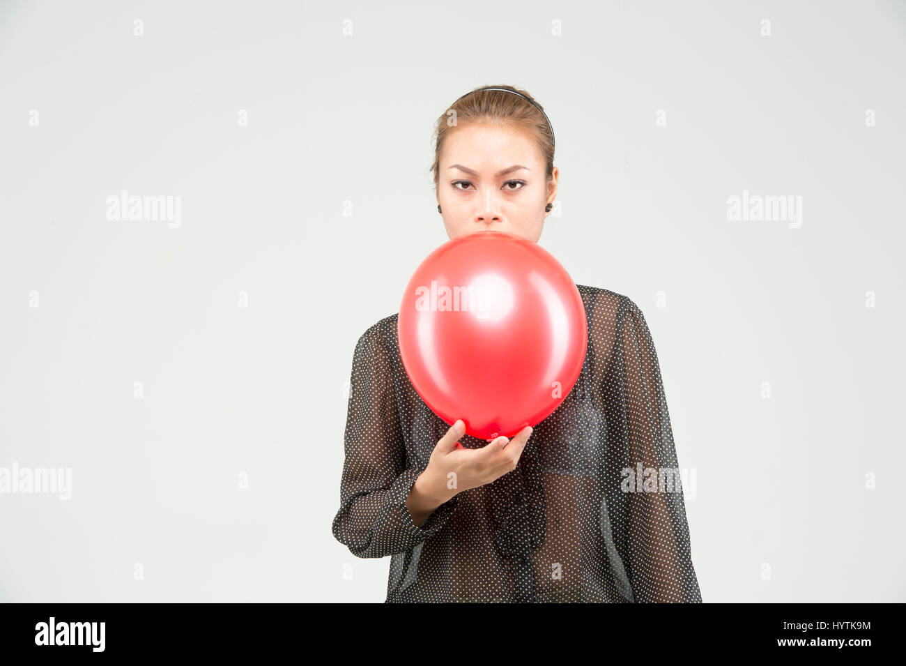 Happy beautiful asian girl play with red balloon. Action with balloon ...