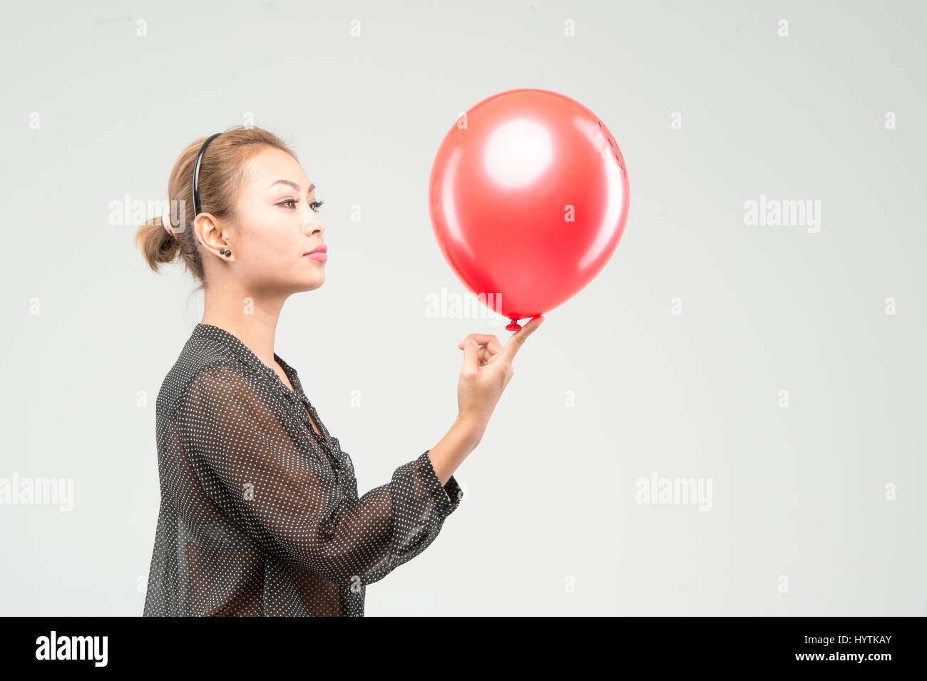 Happy beautiful asian girl play with red balloon. Action with balloon ...