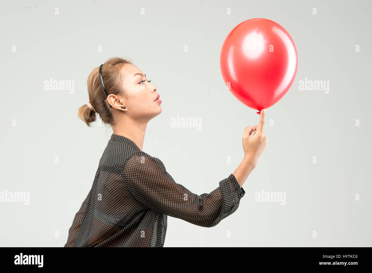 Happy beautiful asian girl play with red balloon. Action with balloon ...