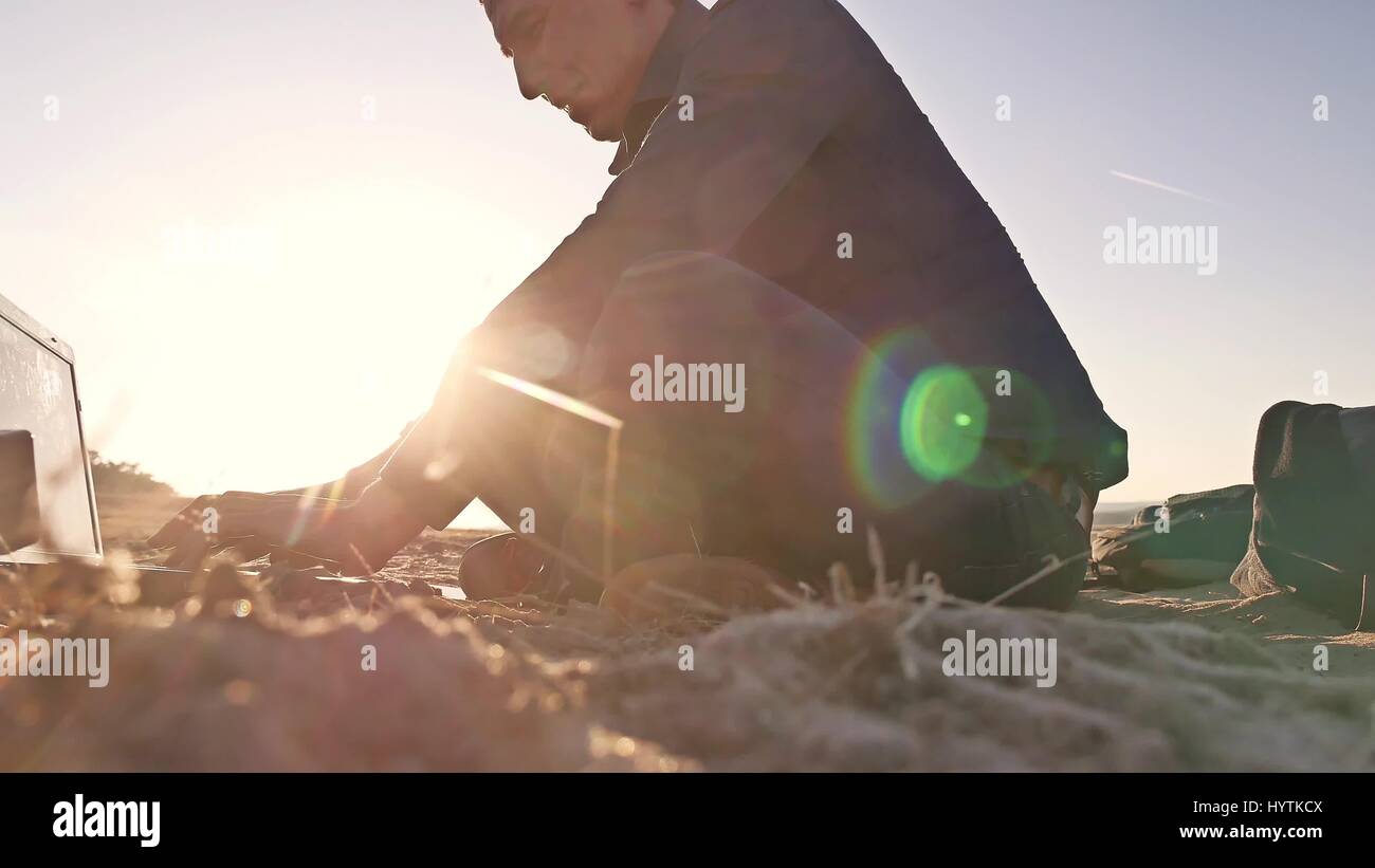 Freelancer. Man silhouette working on laptop freelancer sitting on the ...