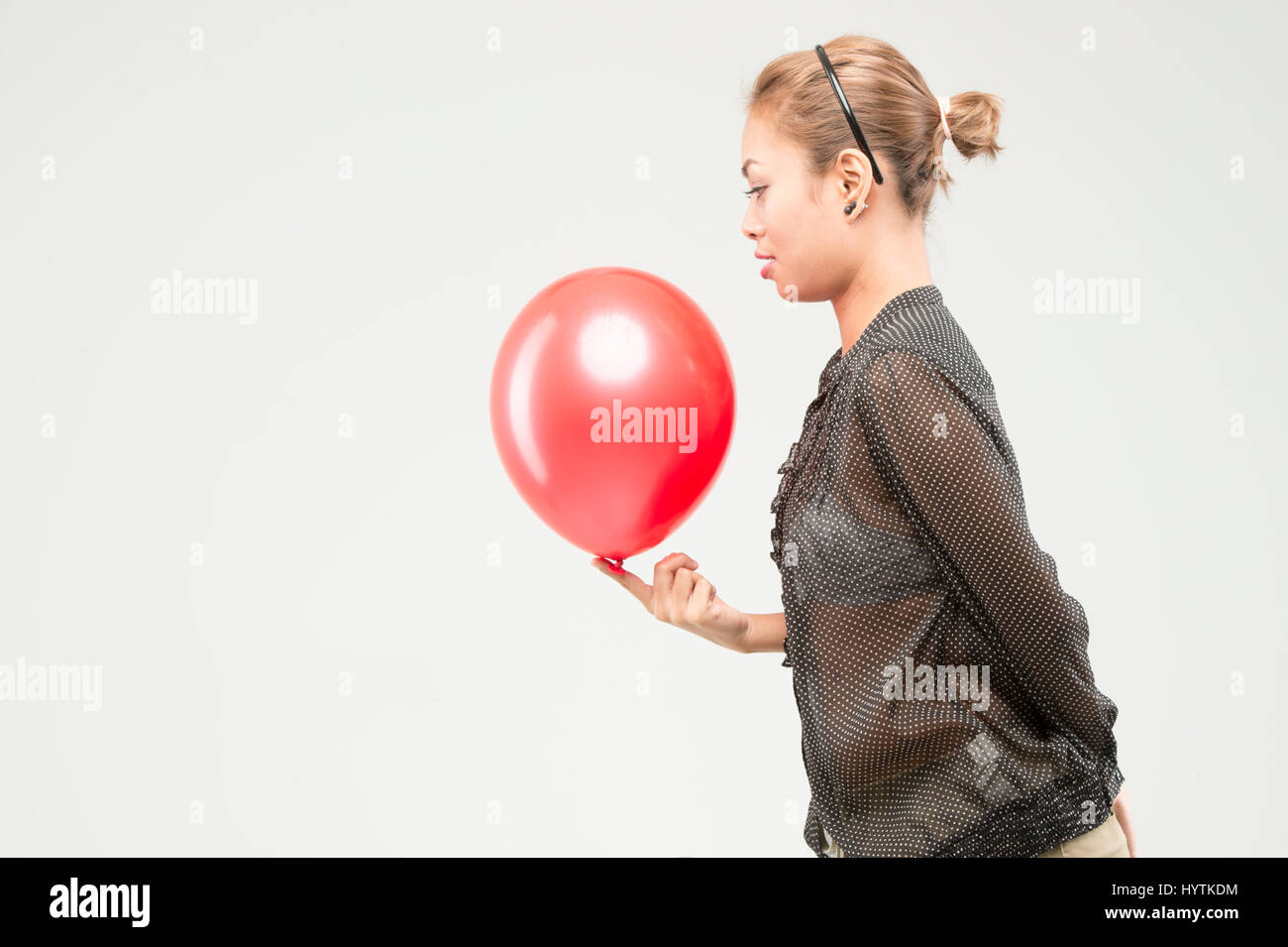 Happy beautiful asian girl play with red balloon. Action with balloon ...