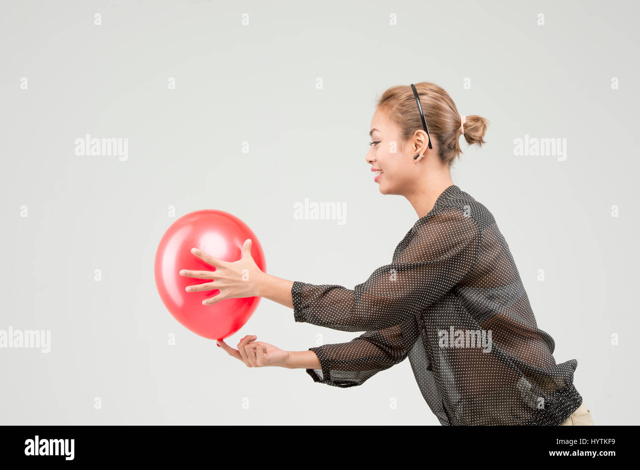 Happy beautiful asian girl play with red balloon. Action with balloon ...