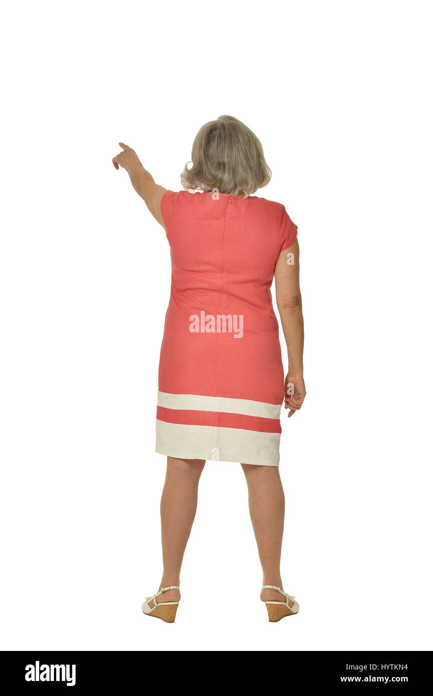 Elderly woman in dress pointing on white background Stock Photo - Alamy