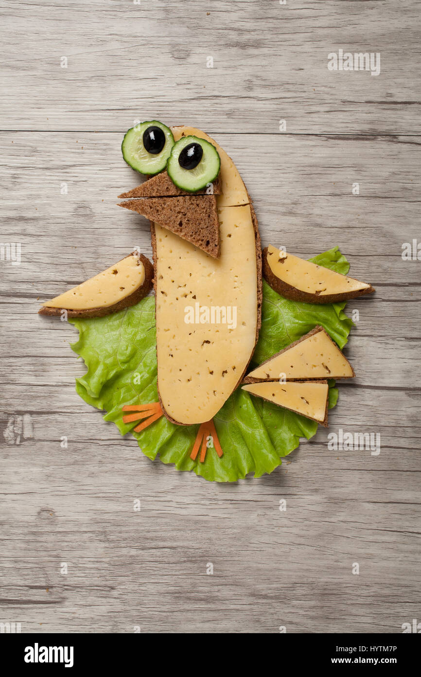 Amusing sandwich bird made on wooden background Stock Photo - Alamy