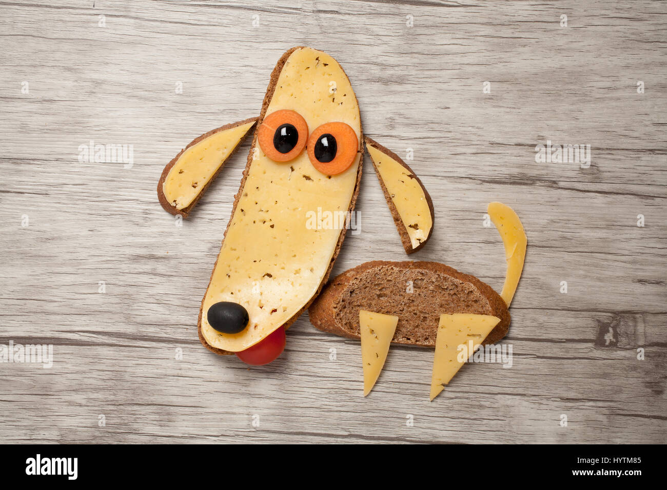Amazing dog made of bread and cheese on board Stock Photo - Alamy