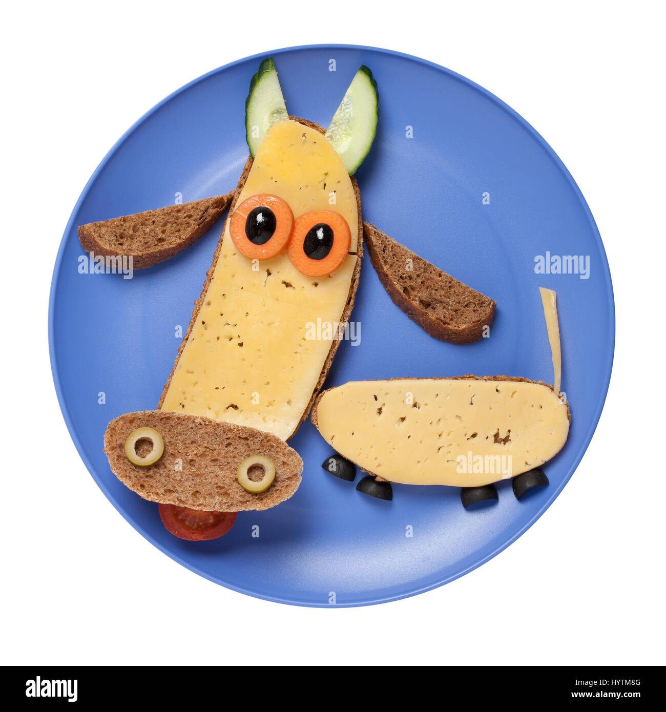 Cow made of black bread and cheese on blue plate Stock Photo - Alamy
