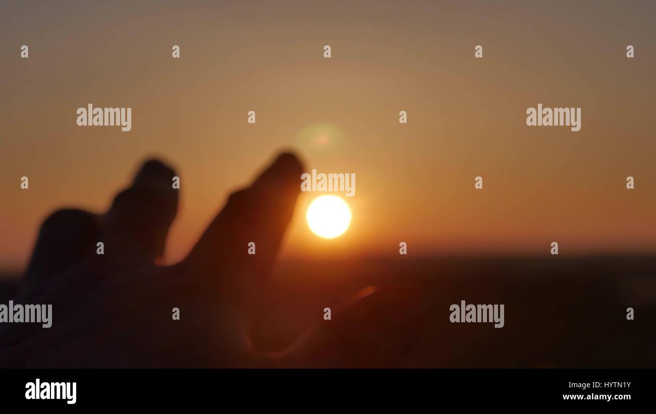 travel. man looks at the sun travel through her hand lifestyle Stock ...