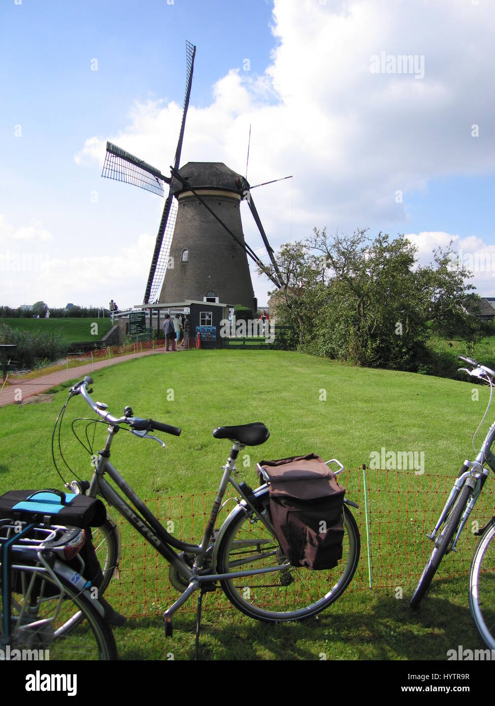 Dutch windmill with bikes on a dike Stock Photo - Alamy