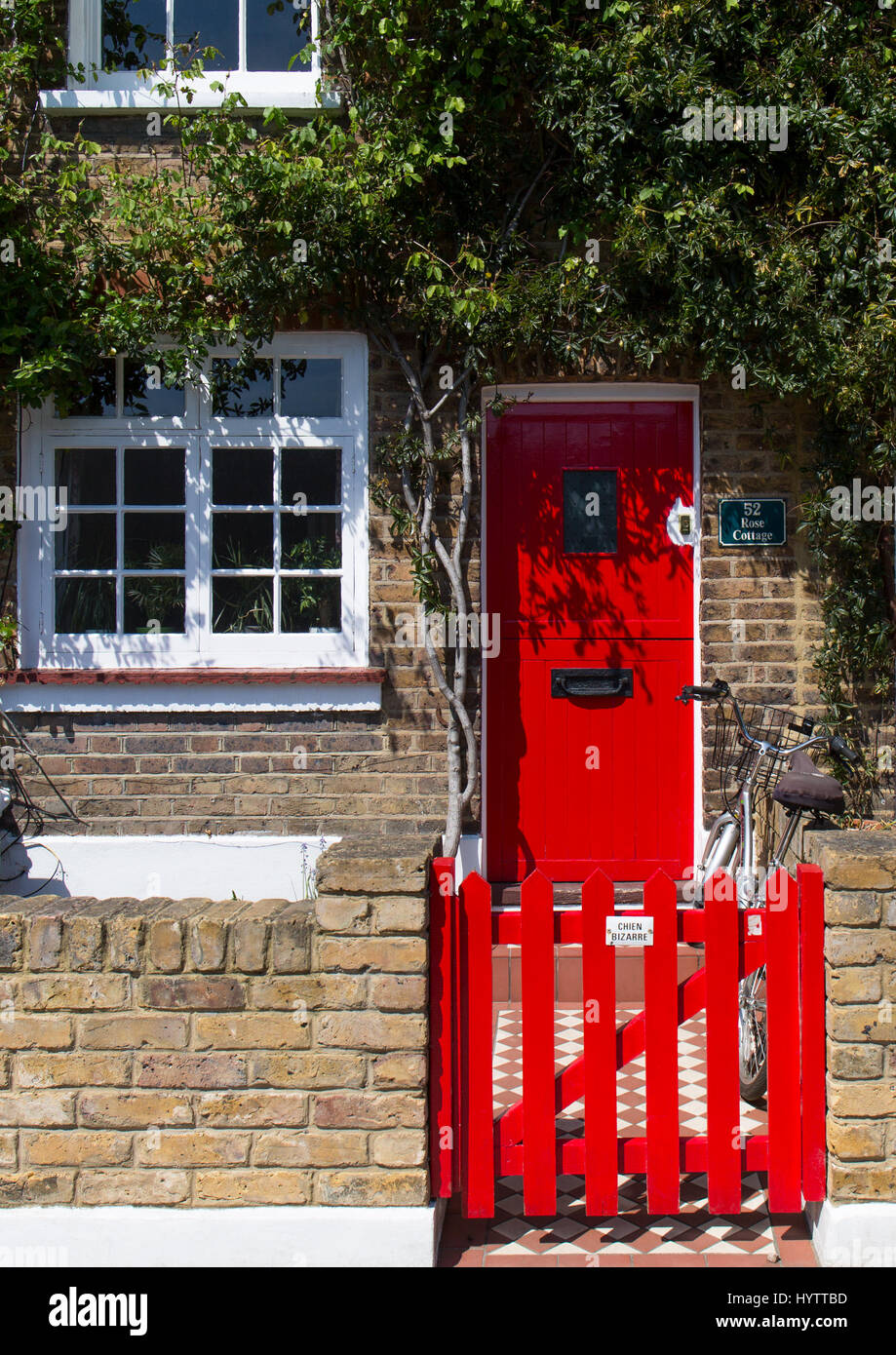 Red door and wooden gate of a traditional English house Stock Photo - Alamy