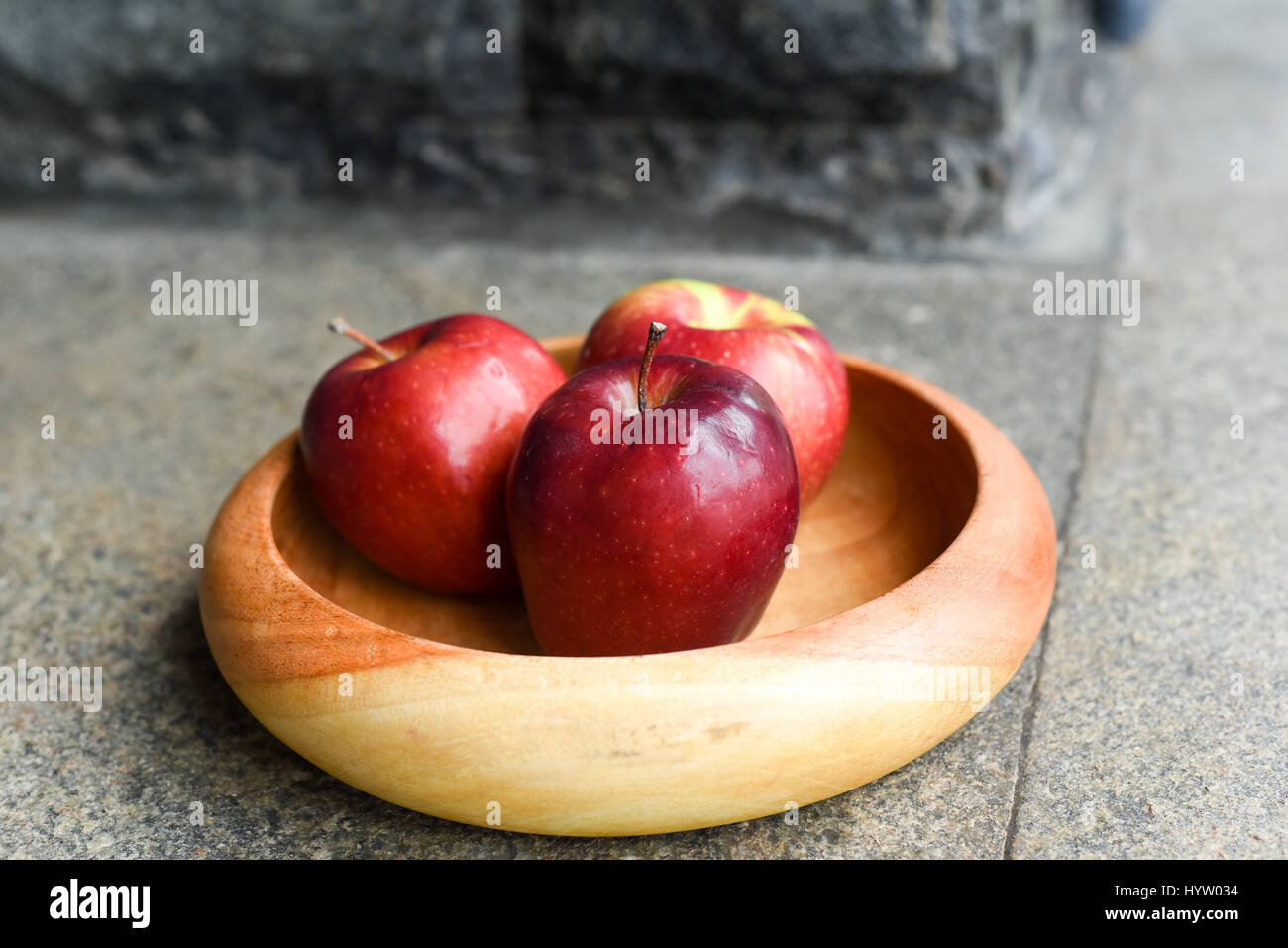 Red apples on wooden plate Stock Photo - Alamy