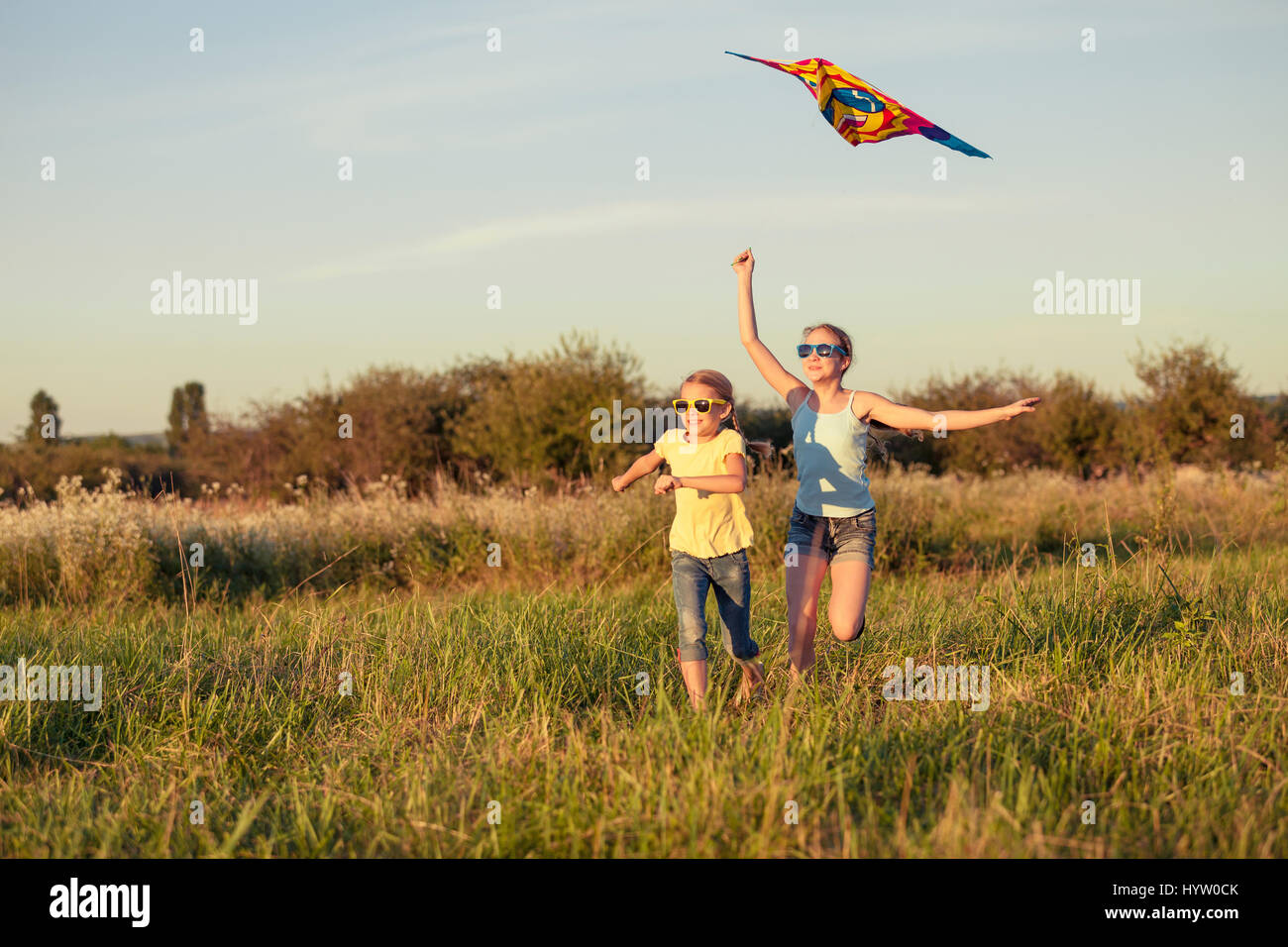 Happy children playing on the field at the day time. Concept of ...