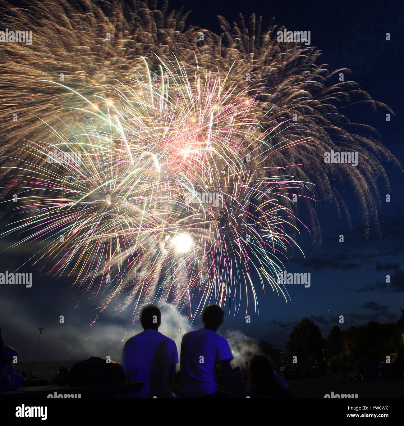 Two children watch fireworks explode on the fourth of July Stock Photo ...