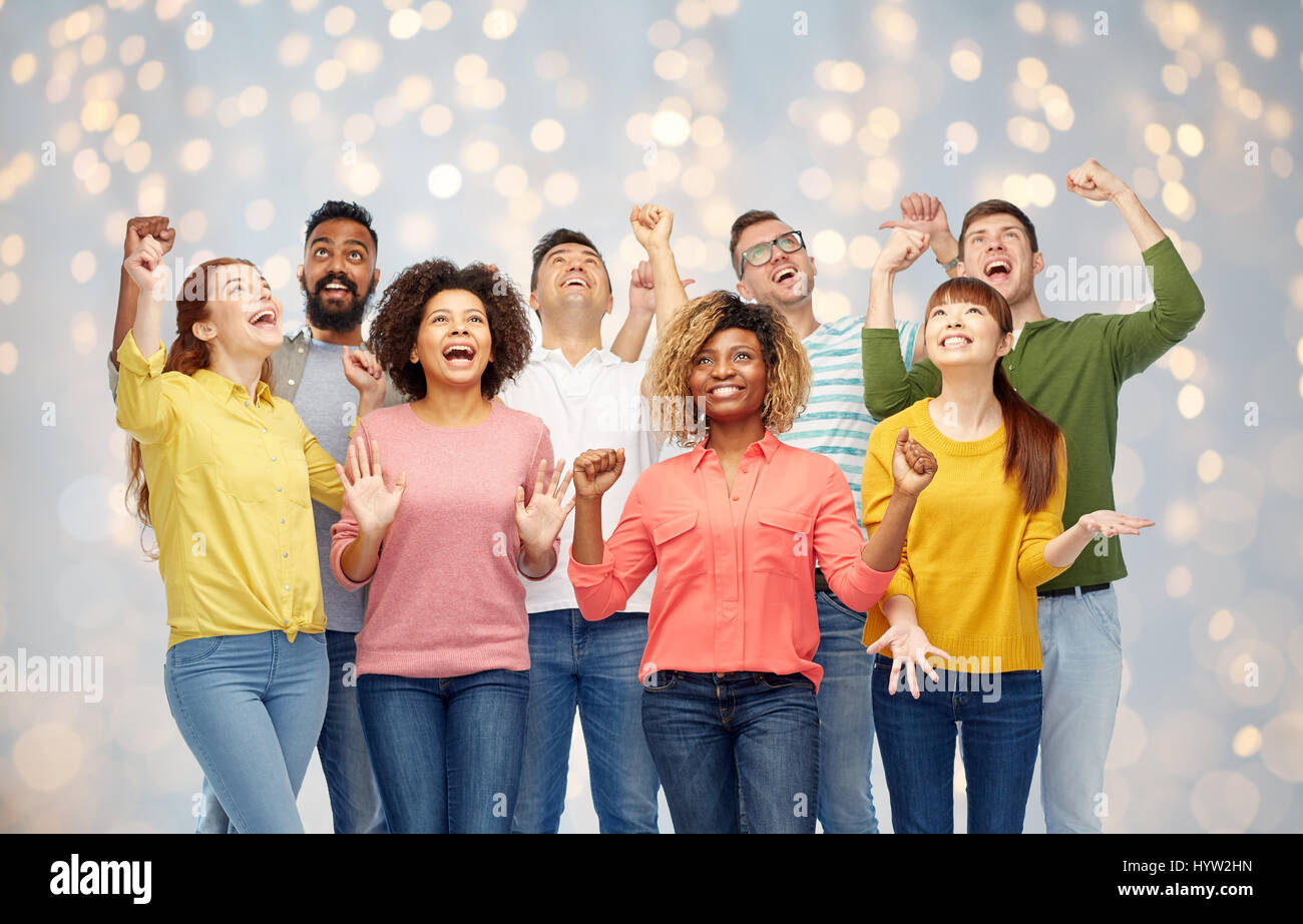 international group of happy people over lights Stock Photo - Alamy