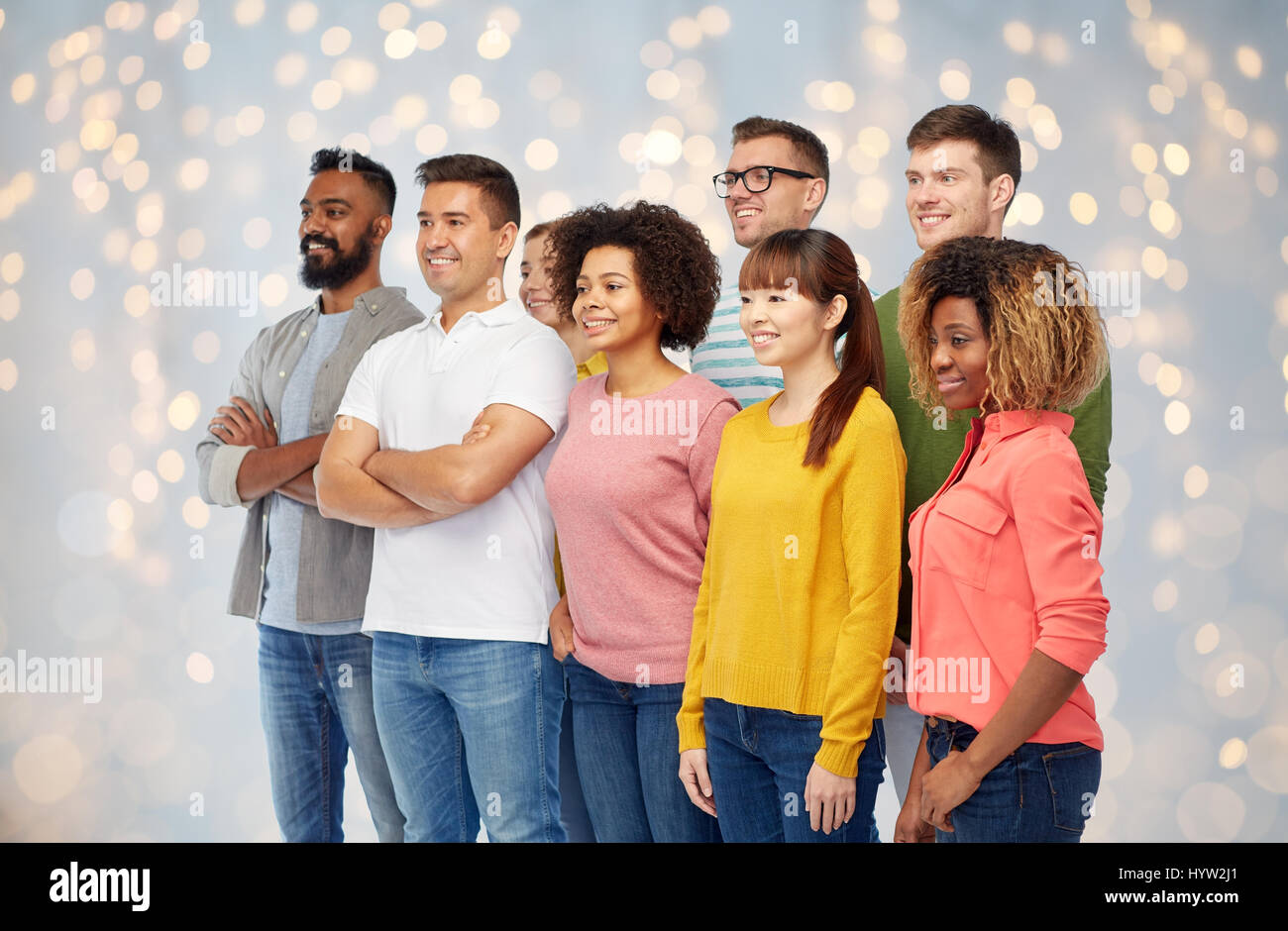 international group of happy people over lights Stock Photo - Alamy