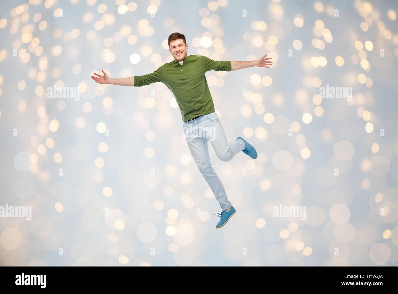 smiling young man jumping in air Stock Photo - Alamy