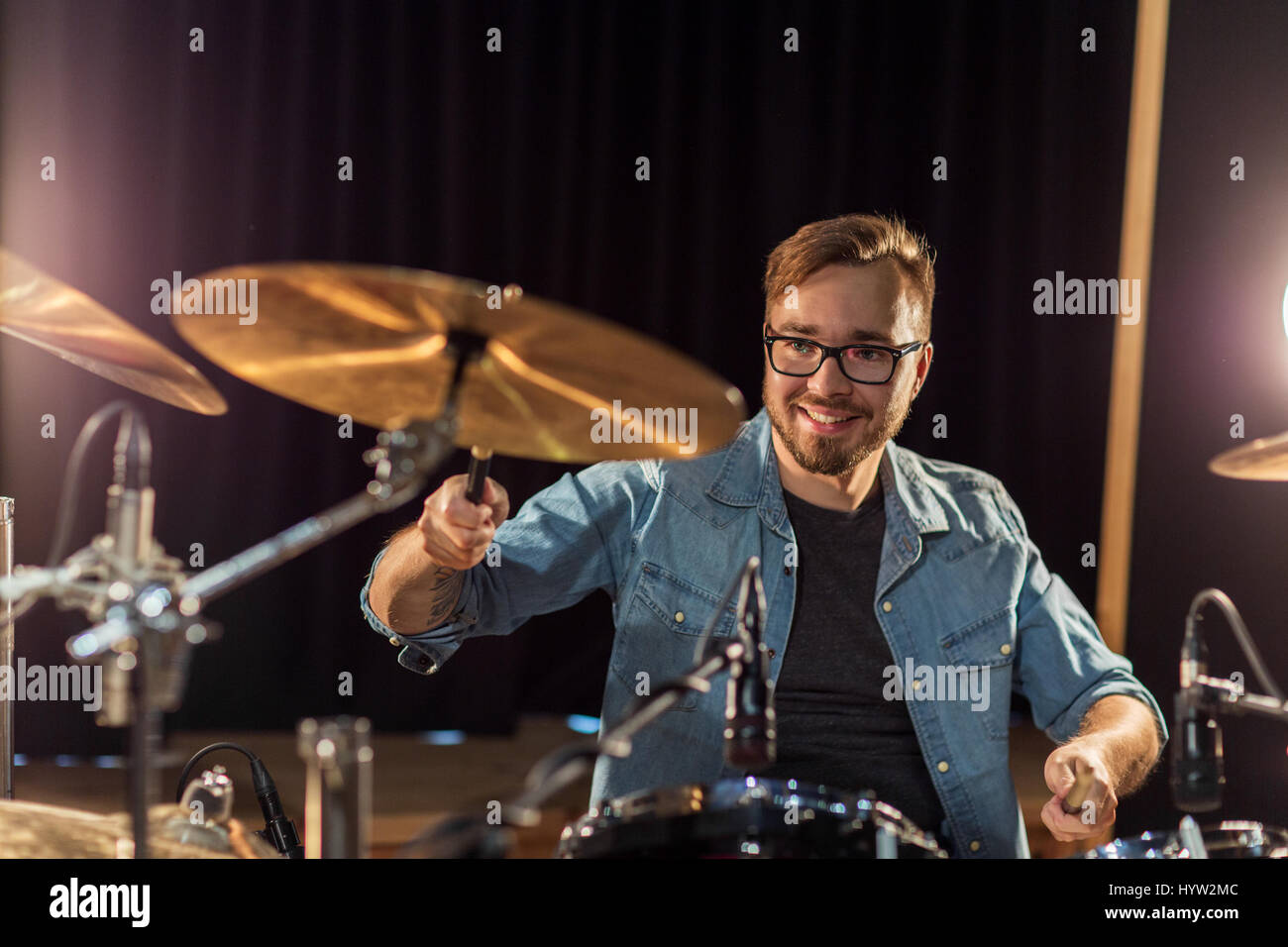 male musician playing drums and cymbals at concert Stock Photo - Alamy