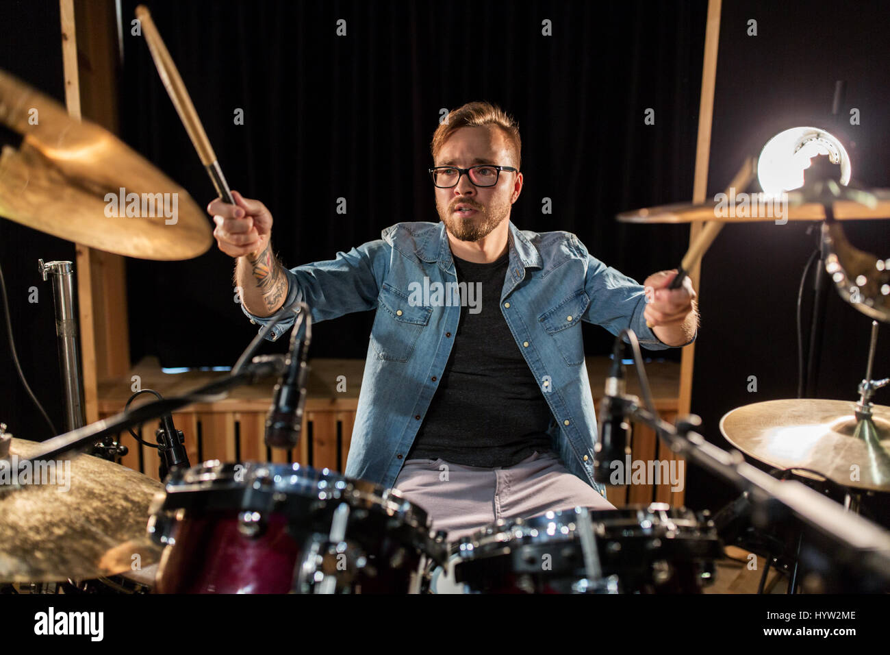 male musician playing drums and cymbals at concert Stock Photo - Alamy