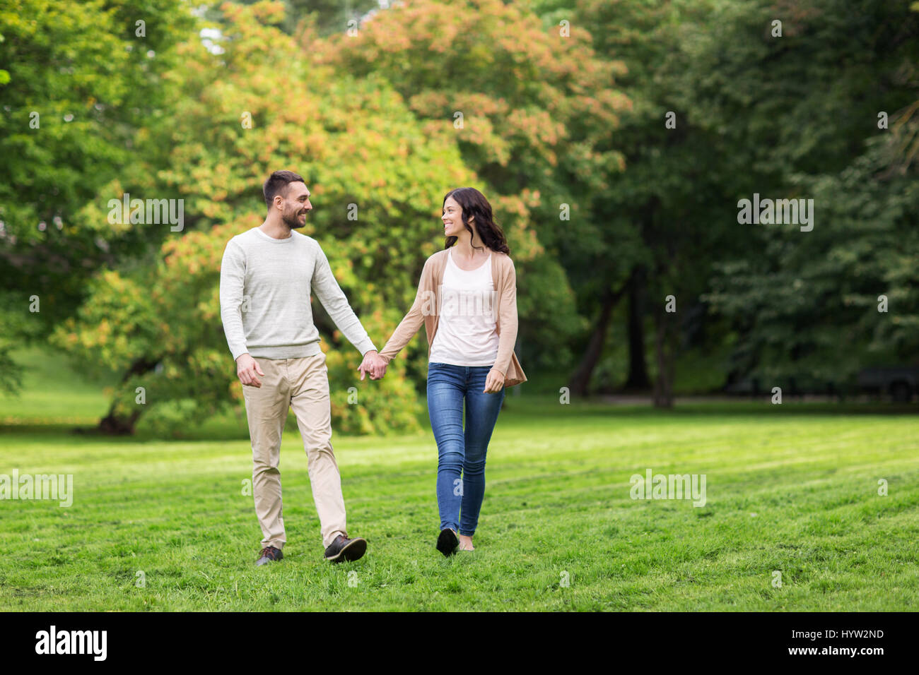 happy couple walking in summer park Stock Photo - Alamy