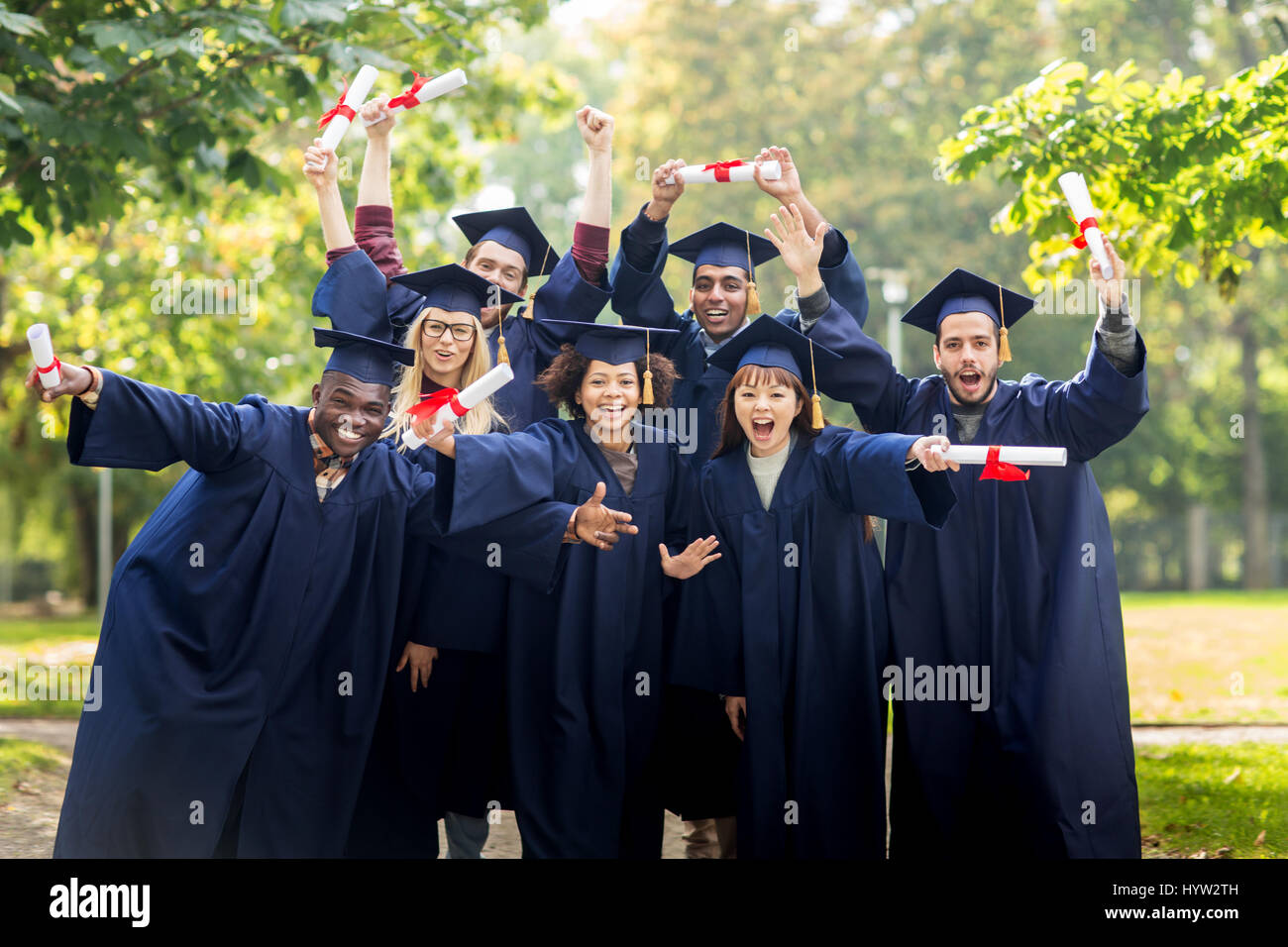 happy students in mortar boards with diplomas Stock Photo - Alamy