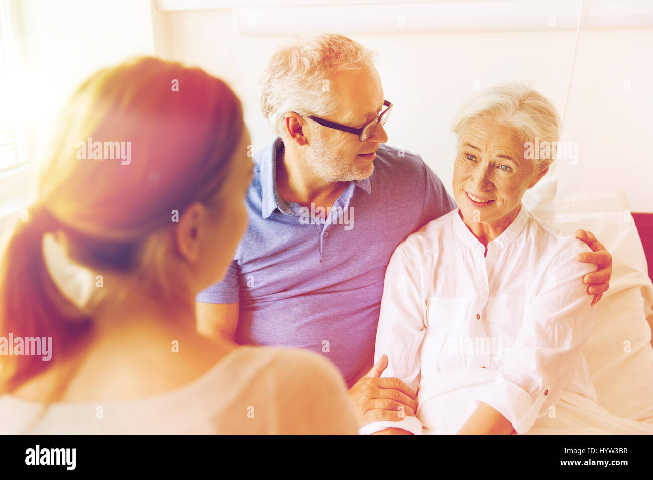 happy family visiting senior woman at hospital Stock Photo - Alamy
