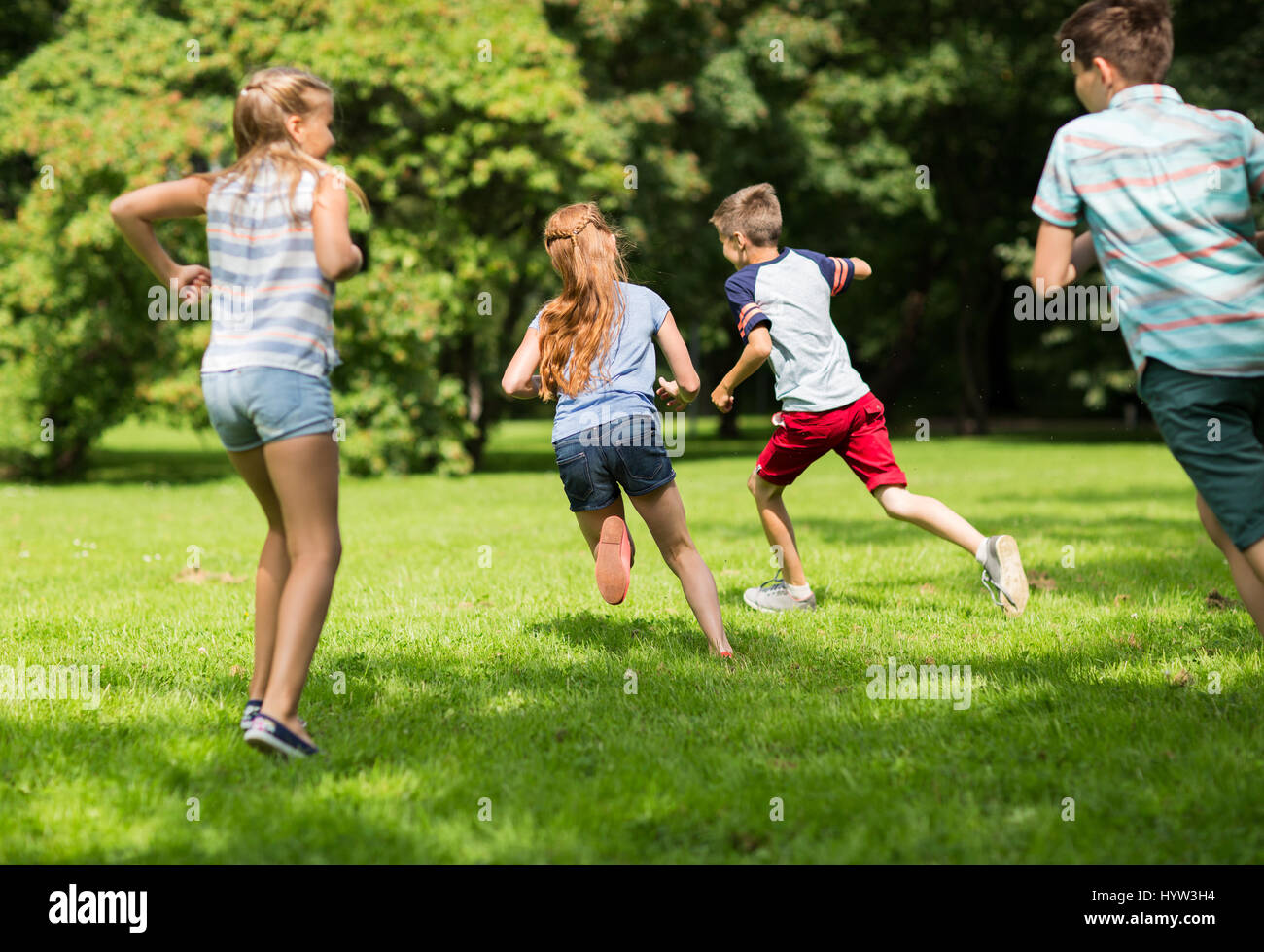 group of happy kids or friends playing outdoors Stock Photo - Alamy