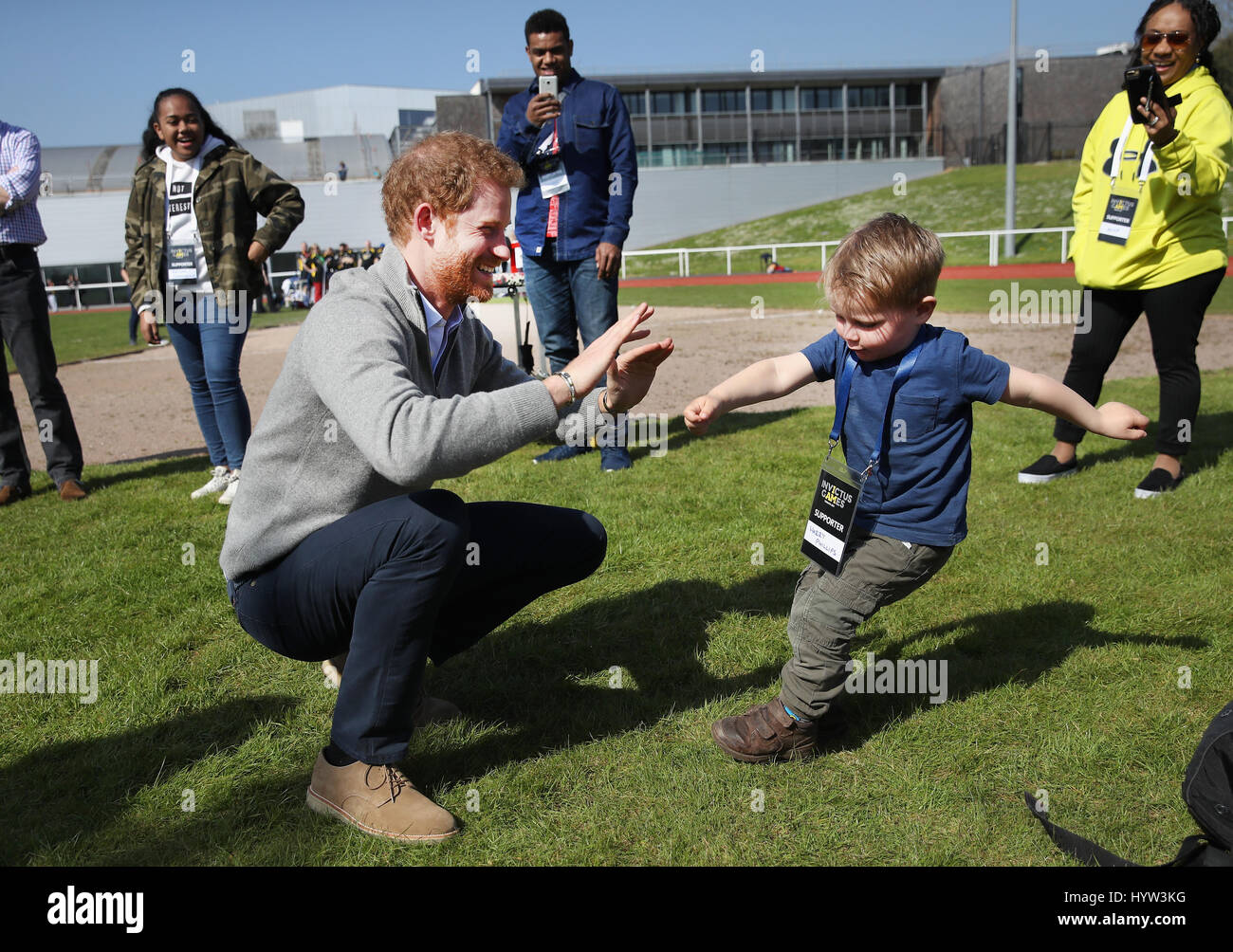 Prince Harry plays with Harry Phillips, 2, as he watches the UK team ...