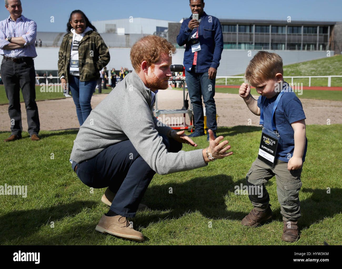 Prince Harry plays with Harry Phillips, 2, as he watches the UK team ...