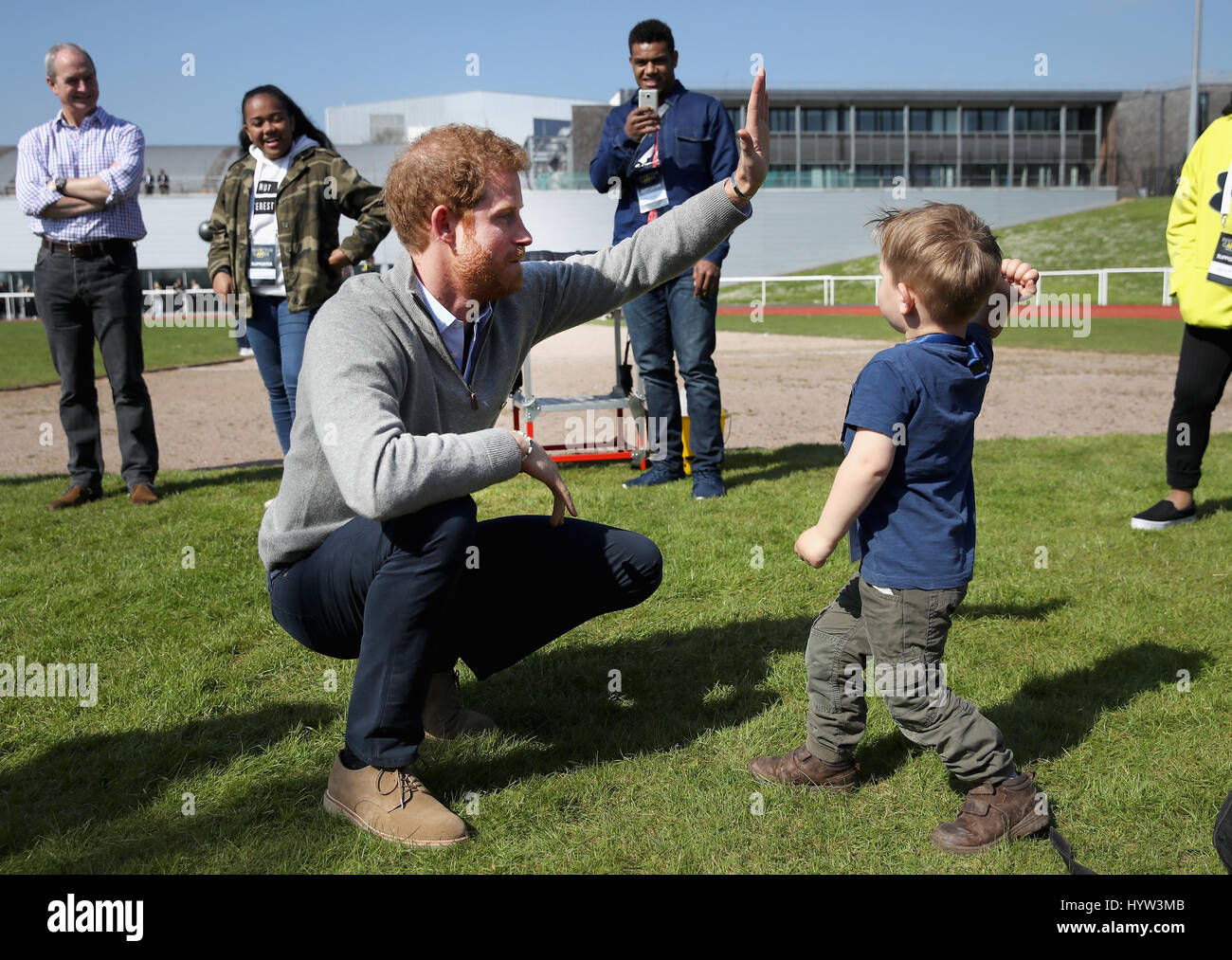 Prince Harry plays with Harry Phillips, 2, as he watches the UK team ...