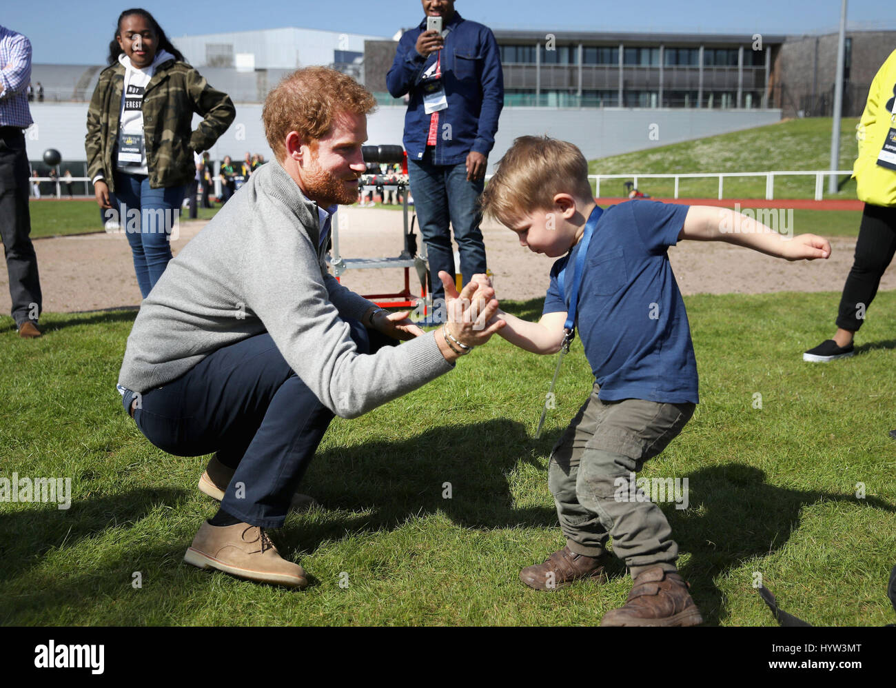 Prince Harry plays with Harry Phillips, 2, as he watches the UK team ...