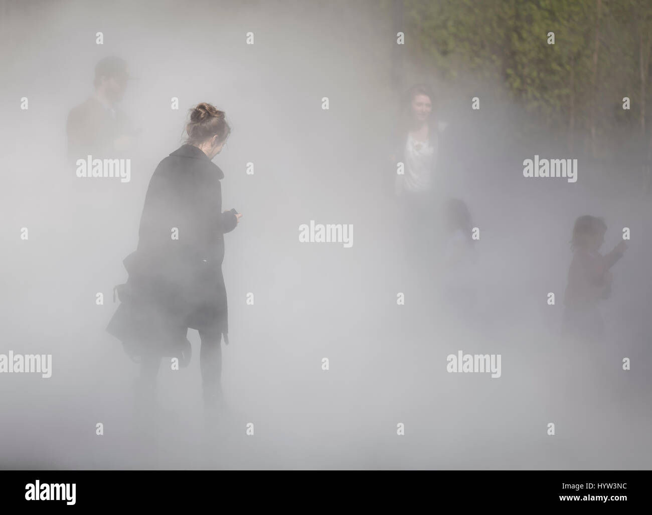 People enjoying themselves walking through fog created at the Tate ...