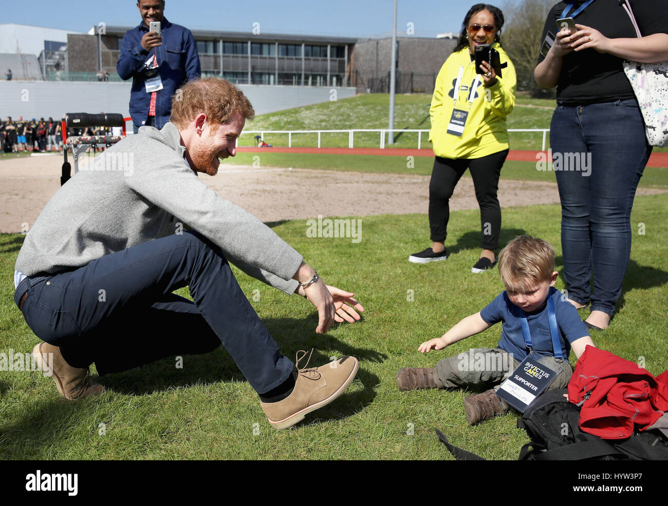 Prince Harry plays with Harry Phillips, 2, as he watches the UK team ...