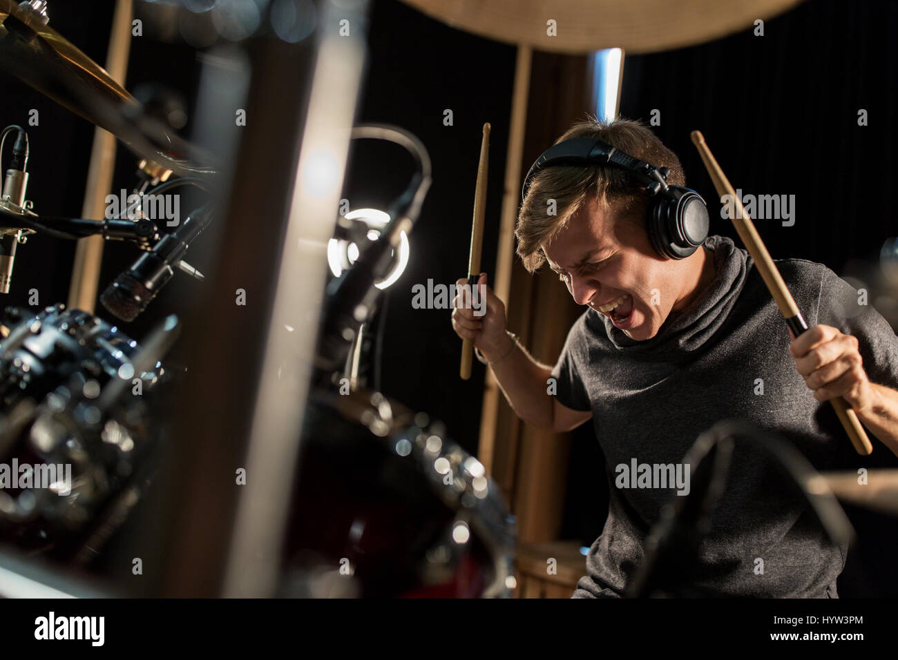 male musician playing drums and cymbals at concert Stock Photo - Alamy