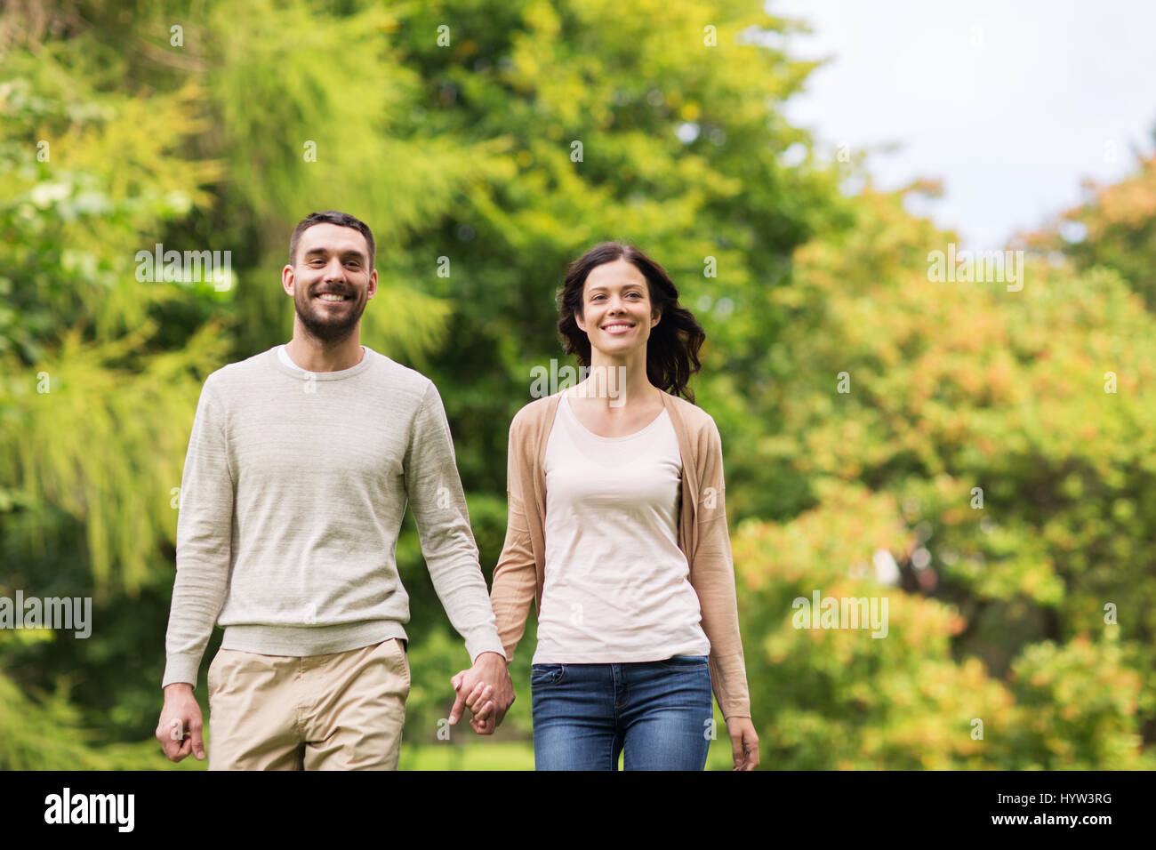 happy couple walking in summer park Stock Photo - Alamy