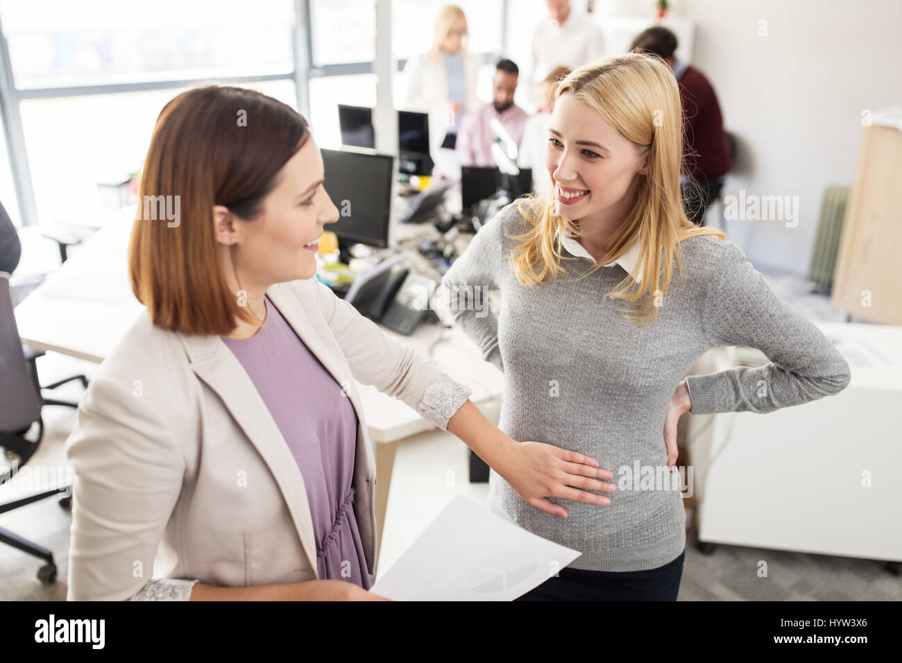 happy colleague with pregnant woman at office Stock Photo - Alamy