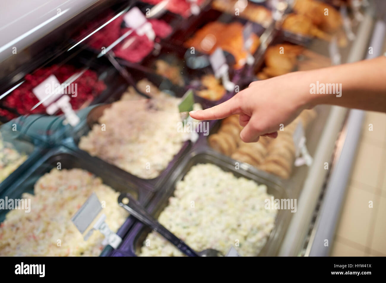 customer hand pointing at salads on grocery stall Stock Photo - Alamy
