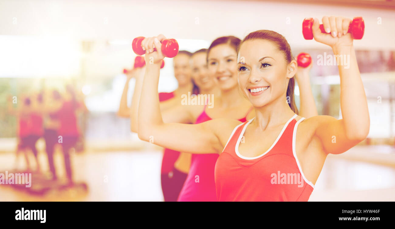 group of smiling people working out with dumbbells Stock Photo - Alamy
