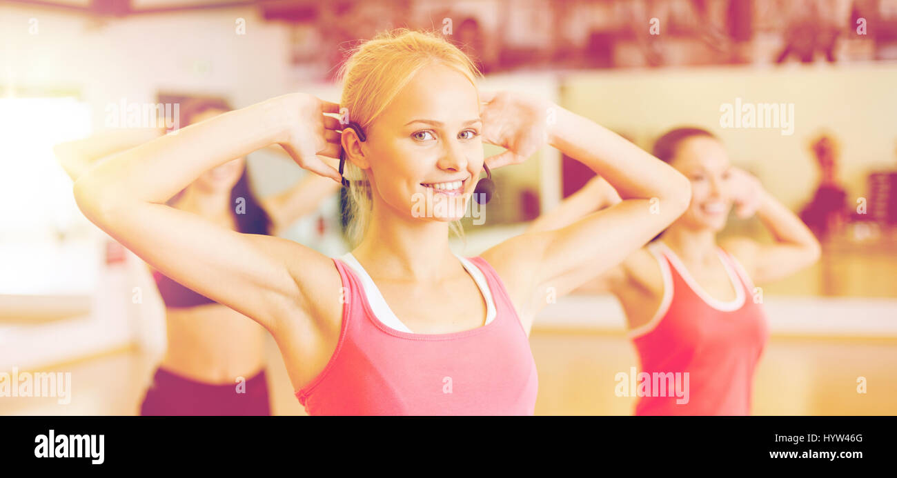 group of smiling people exercising in the gym Stock Photo - Alamy