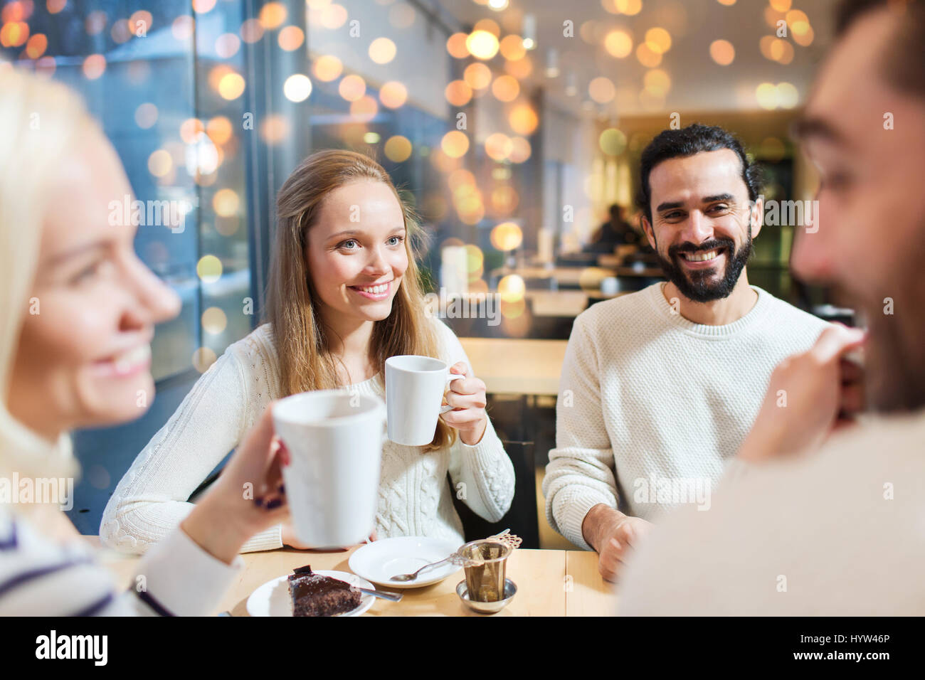 happy friends drinking tea at cafe Stock Photo - Alamy
